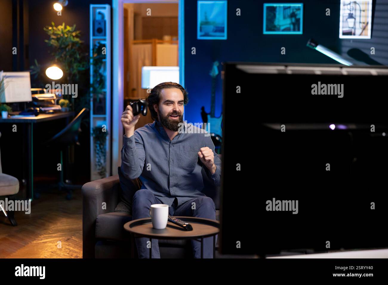 Happy man playing videogames on gaming console, celebrating victory ...