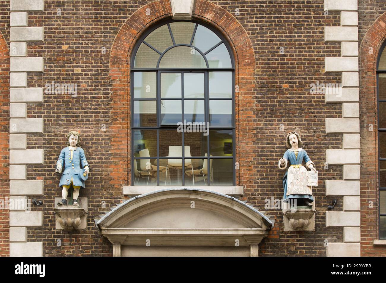 Statues of historical figures adorn the brick facade of the Wren House ...