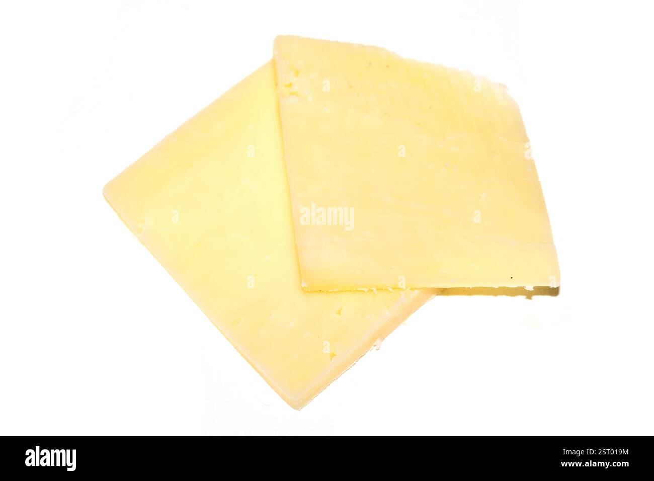 Close up of chedder cheese slices on a white background Stock Photo - Alamy