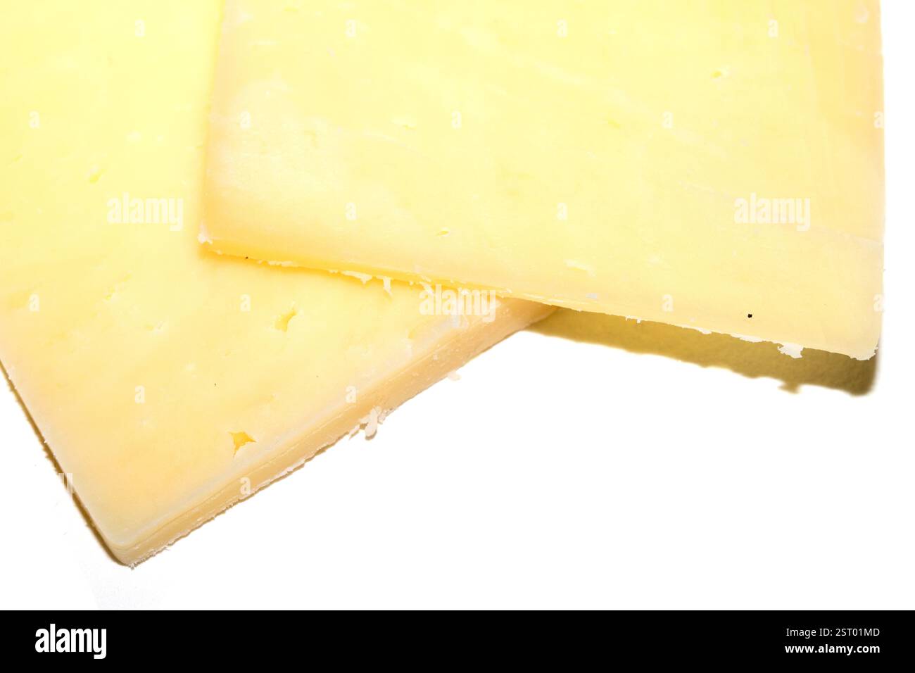 Close up of chedder cheese slices on a white background Stock Photo - Alamy