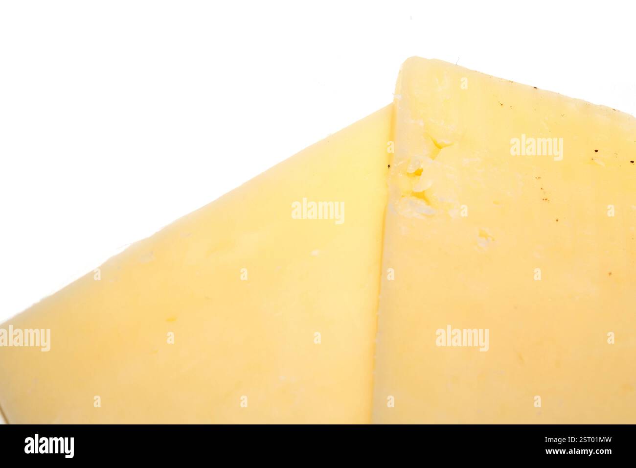 Close up of chedder cheese slices on a white background Stock Photo - Alamy