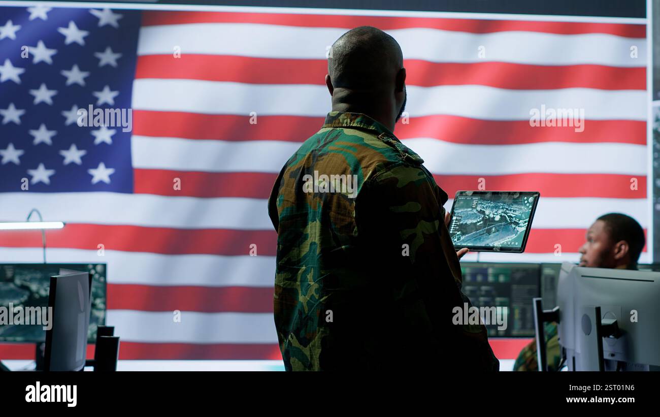 Military personnel in a high tech office handle surveillance activity ...