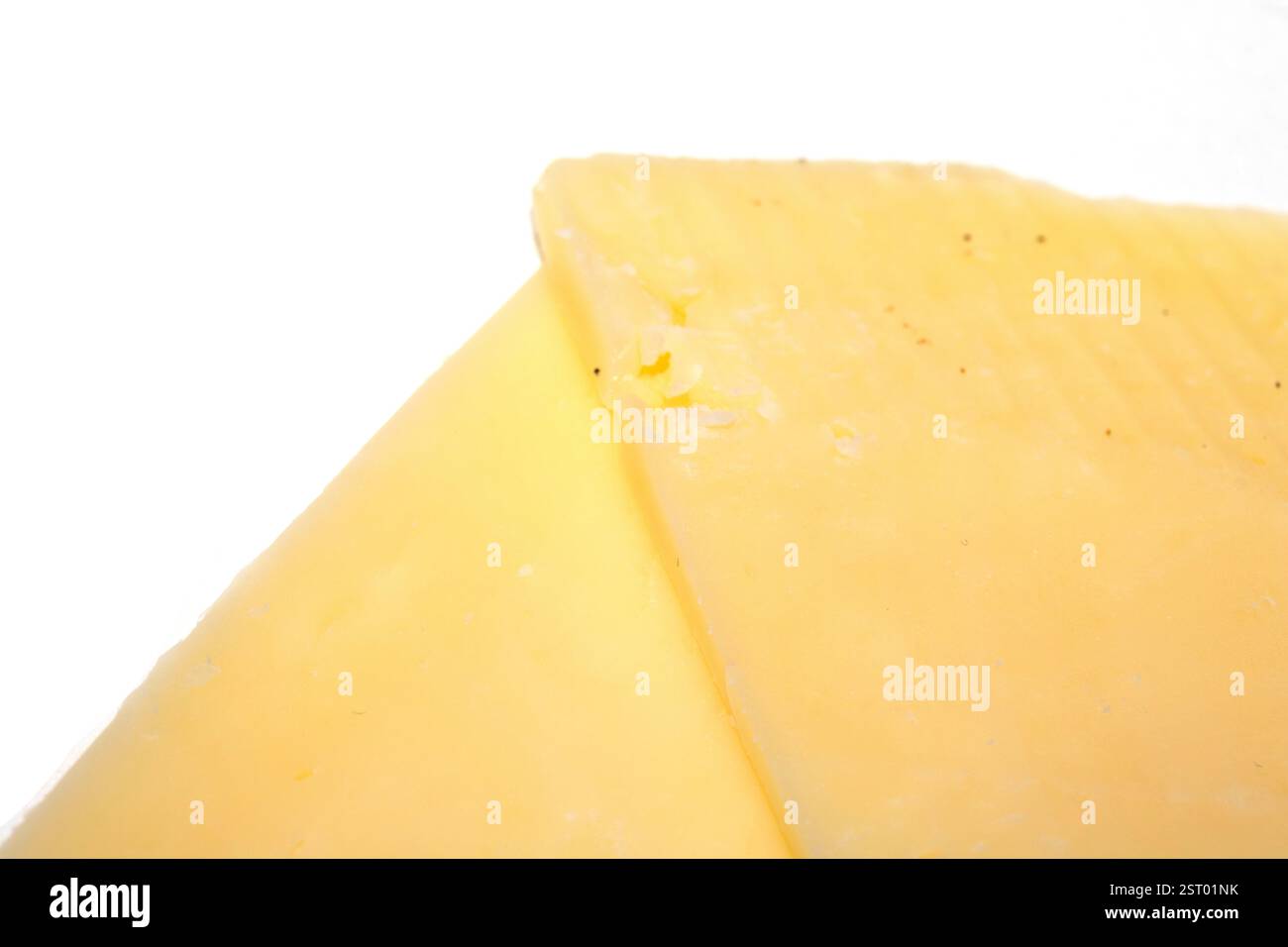 Close up of chedder cheese slices on a white background Stock Photo - Alamy