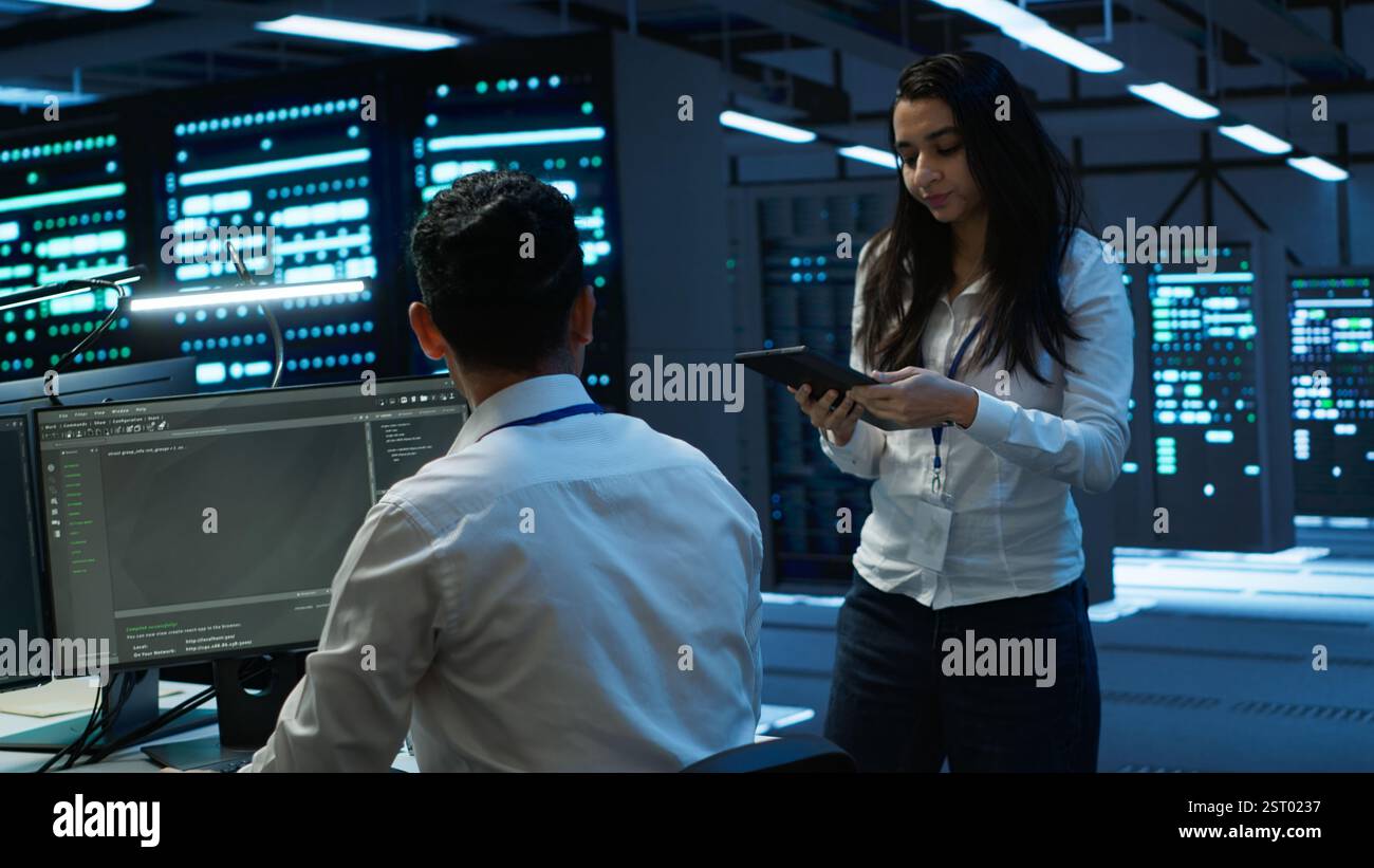 Coworkers In High Tech Data Center Monitoring Security Threats