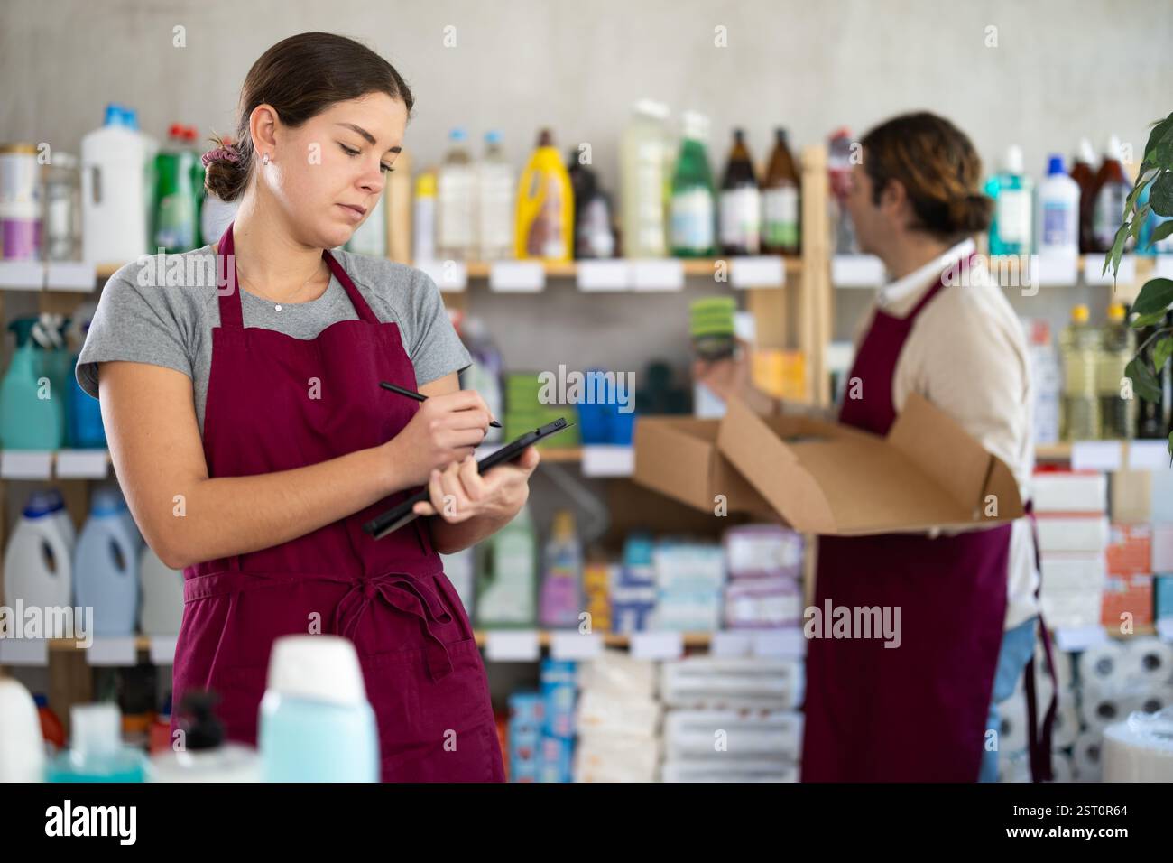 Female household goods store worker using tablet to manage inventory ...