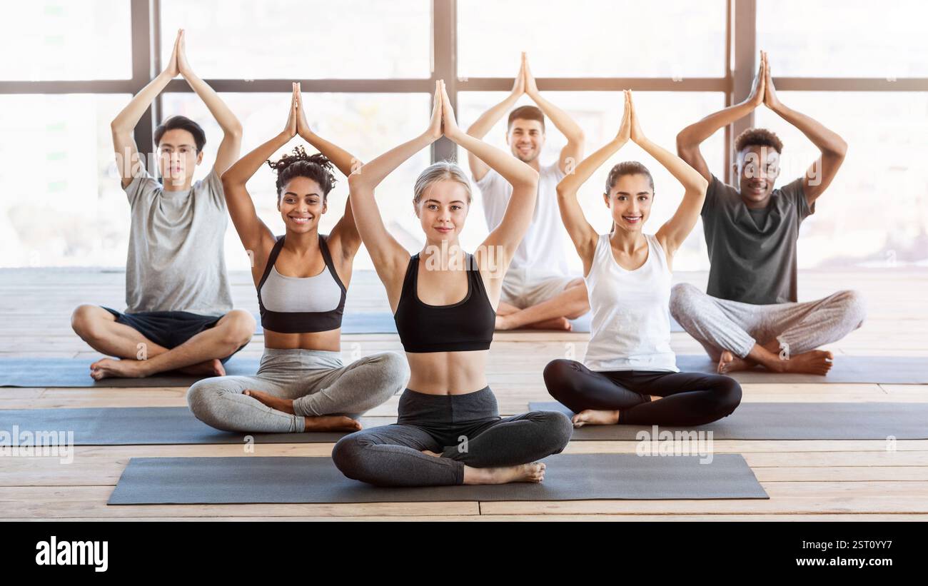 International Yoga Class. Sporty People Sitting In Tree Pose On Mats ...