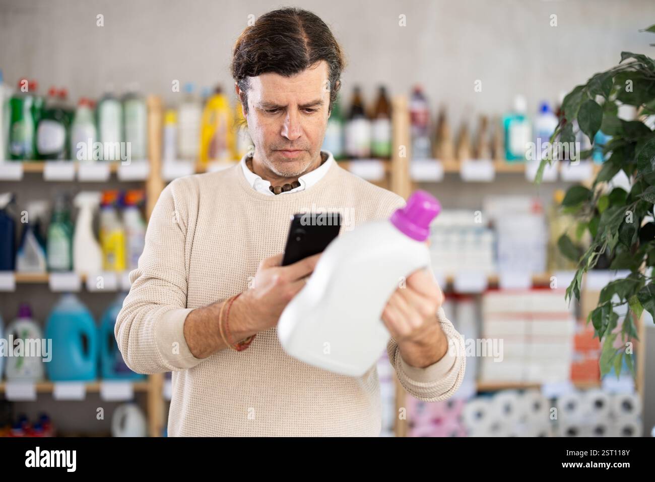 Man scanning barcode of cleansers Stock Photo - Alamy