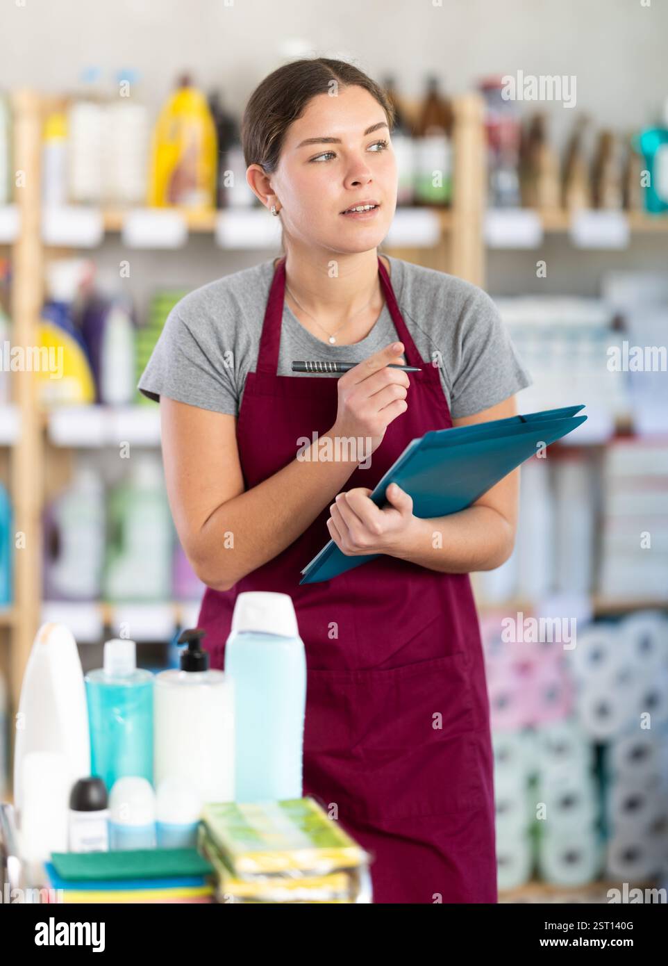 Female supervisor taking notes during inventory in cleaning and hygiene ...