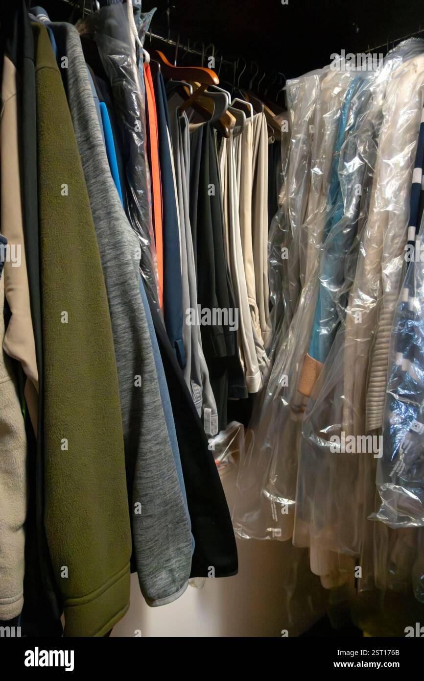 Clothes in a full wardrobe Stock Photo - Alamy