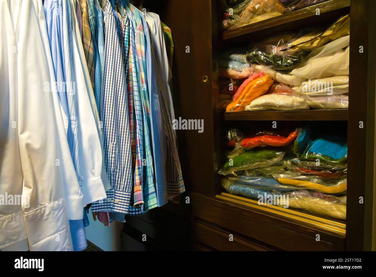 Men's clothes in full wardrobe Stock Photo - Alamy