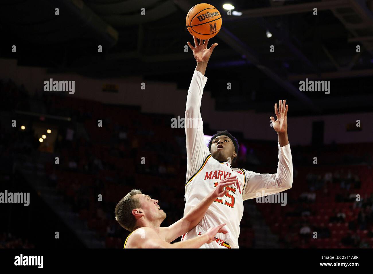 Maryland center Derik Queen (25) takes a shot over Iowa forward Payton ...