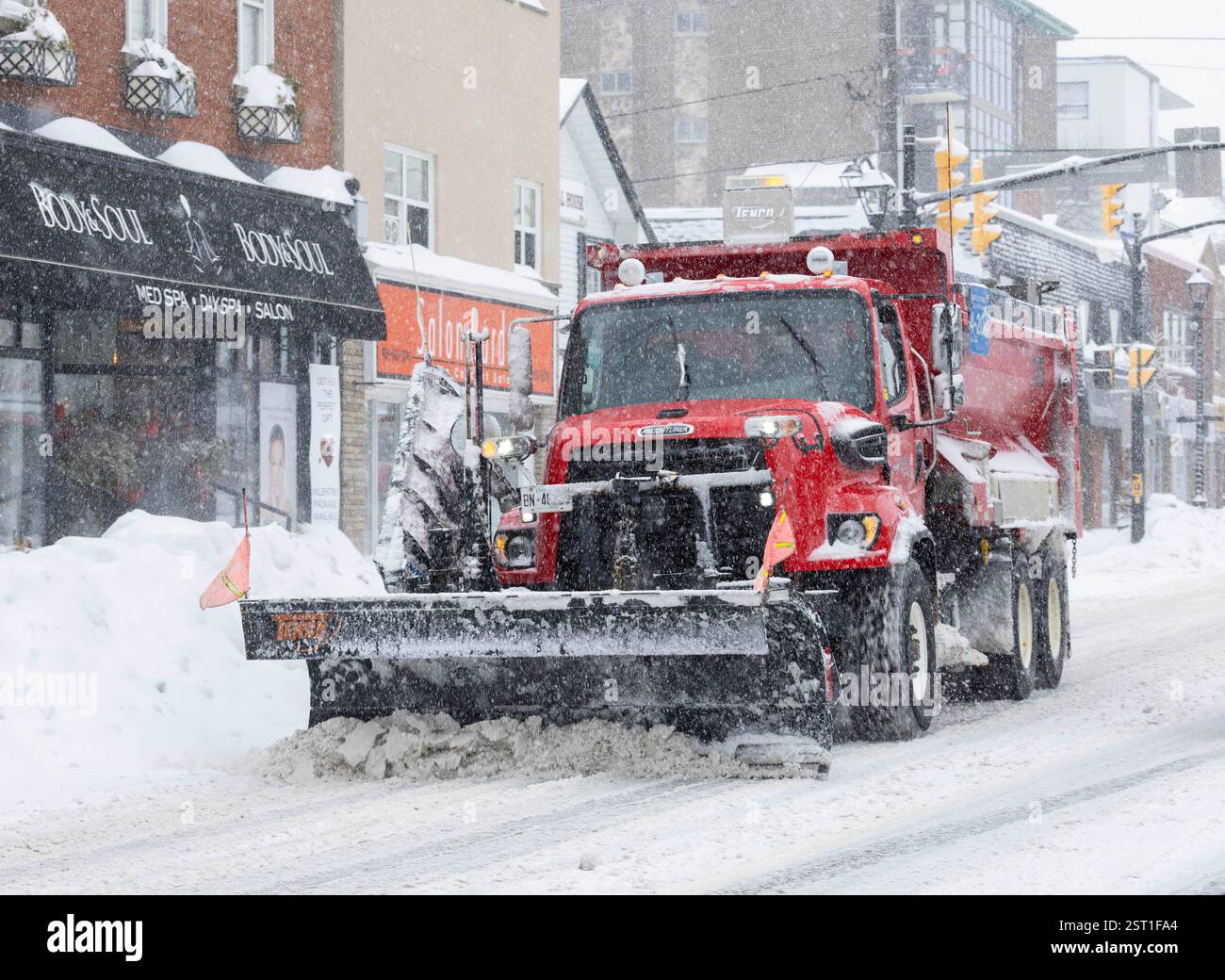 Mississauga, Canada. 16th Feb, 2025. A snowplow clears snow on a street ...