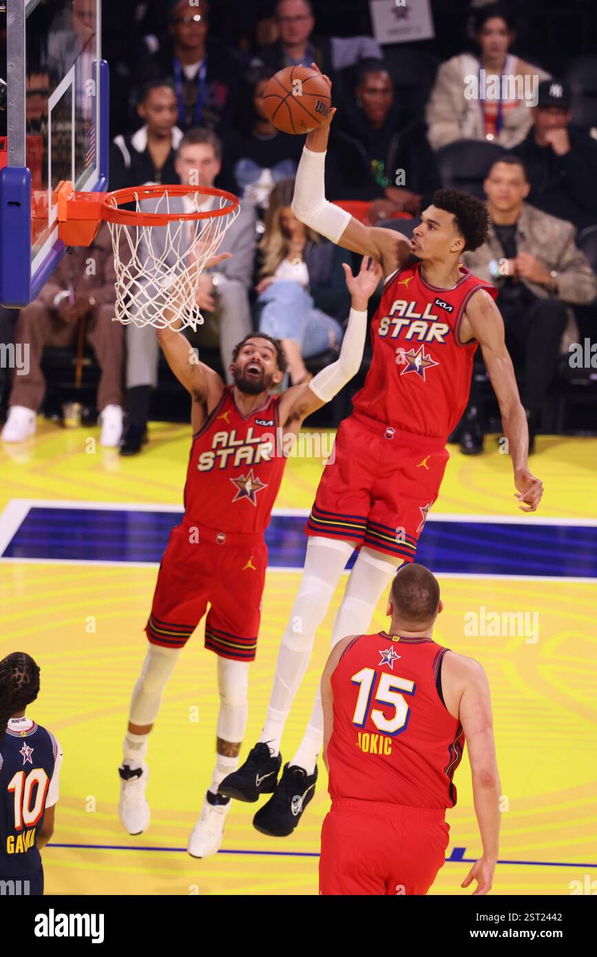 San Antonio Spurs center Victor Wembanyama dunks past teammates Trae ...