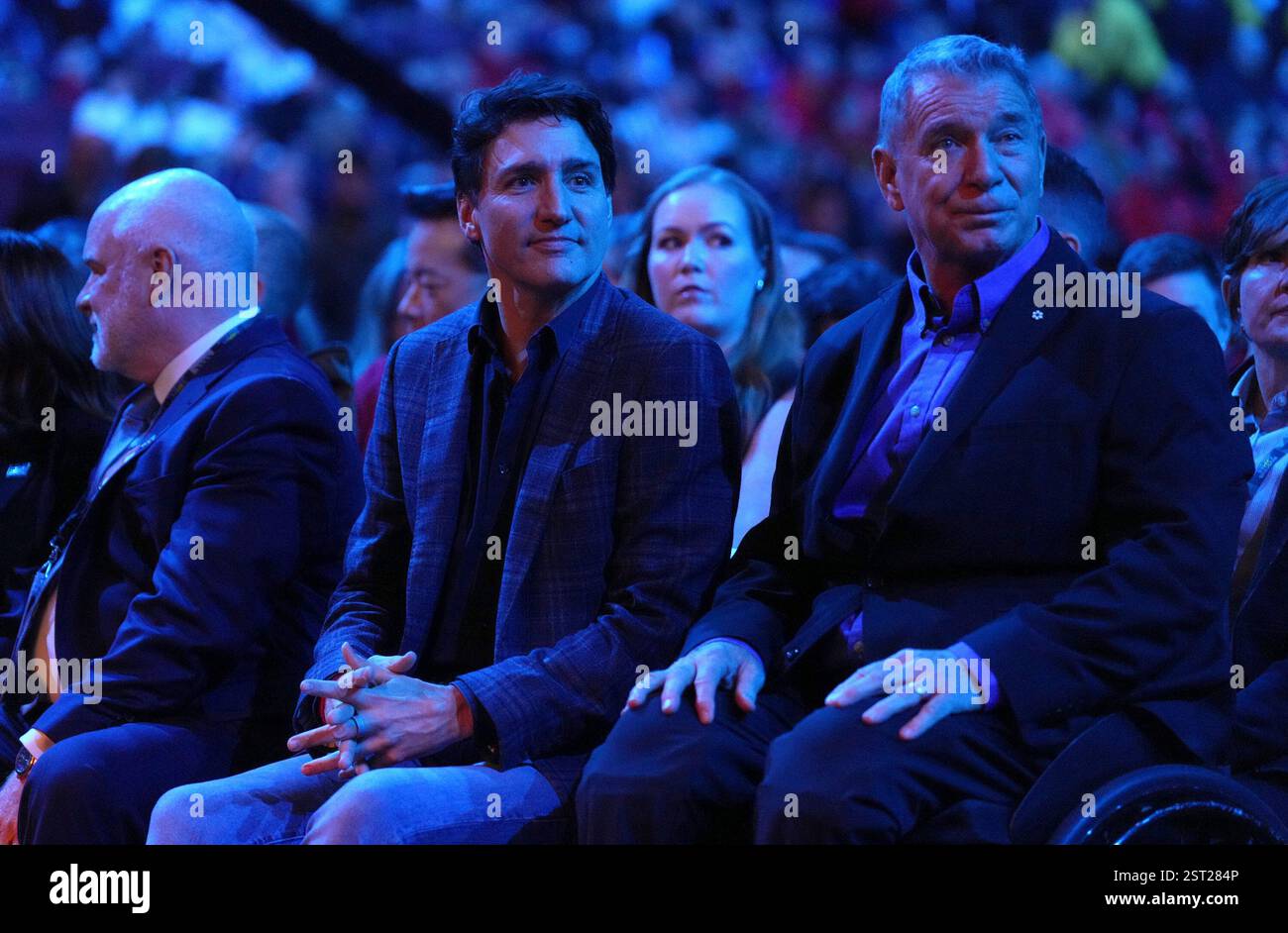 Canada's Prime Minister Justin Trudeau, center, sits with track and ...