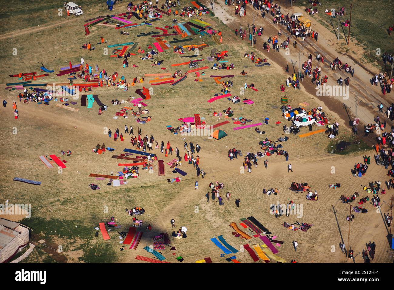 Saris are laid out to dry at the confluence of the Ganges, the Yamuna ...