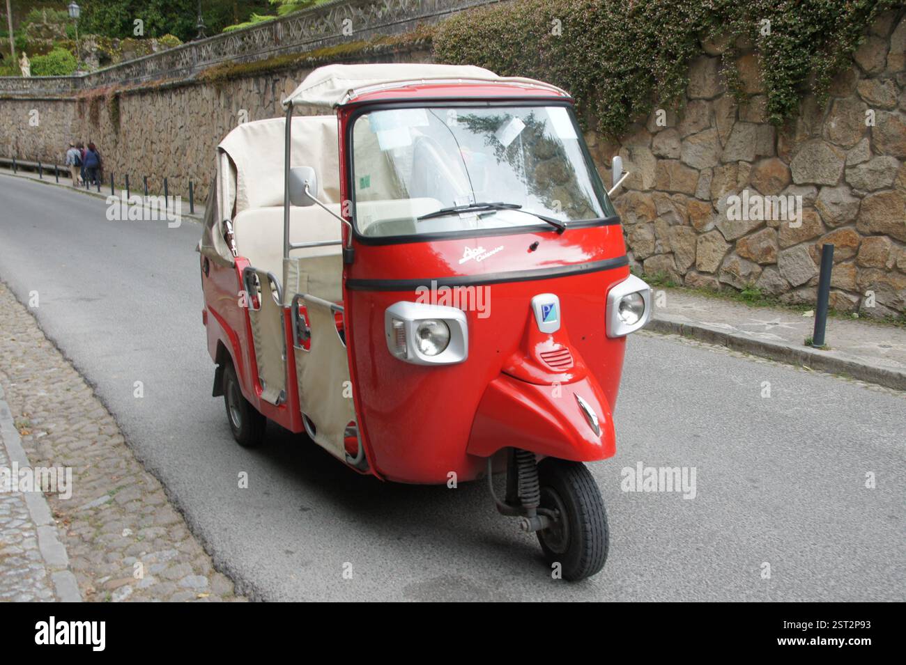 Piaggio Ape Calessino gleams in a showroom. The classic Italian design ...