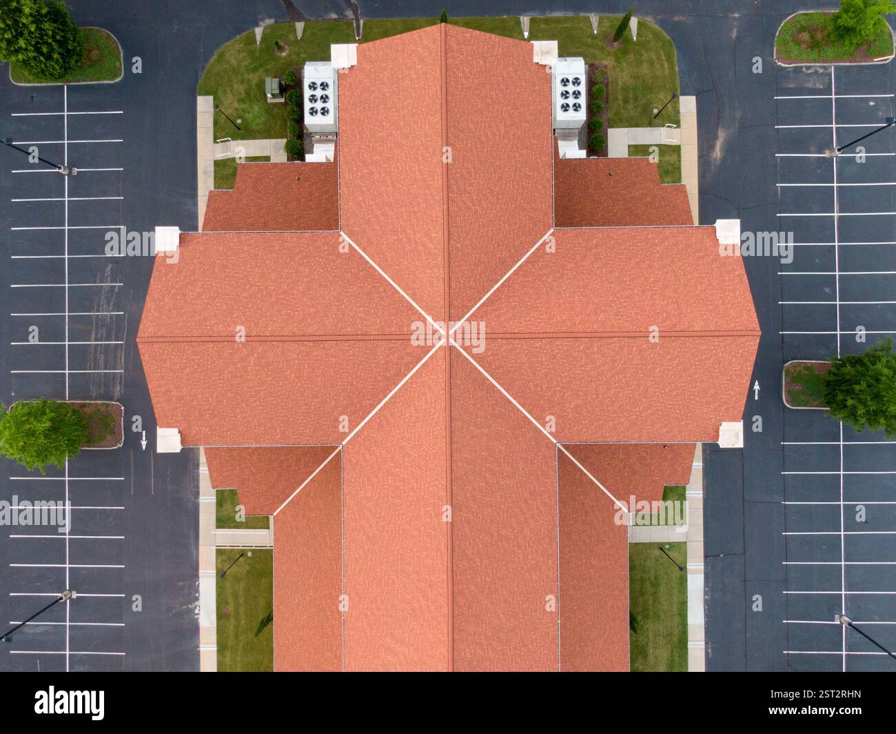 Afternoon Drone Images of a Cross Shaped Church With Red Asphalt ...