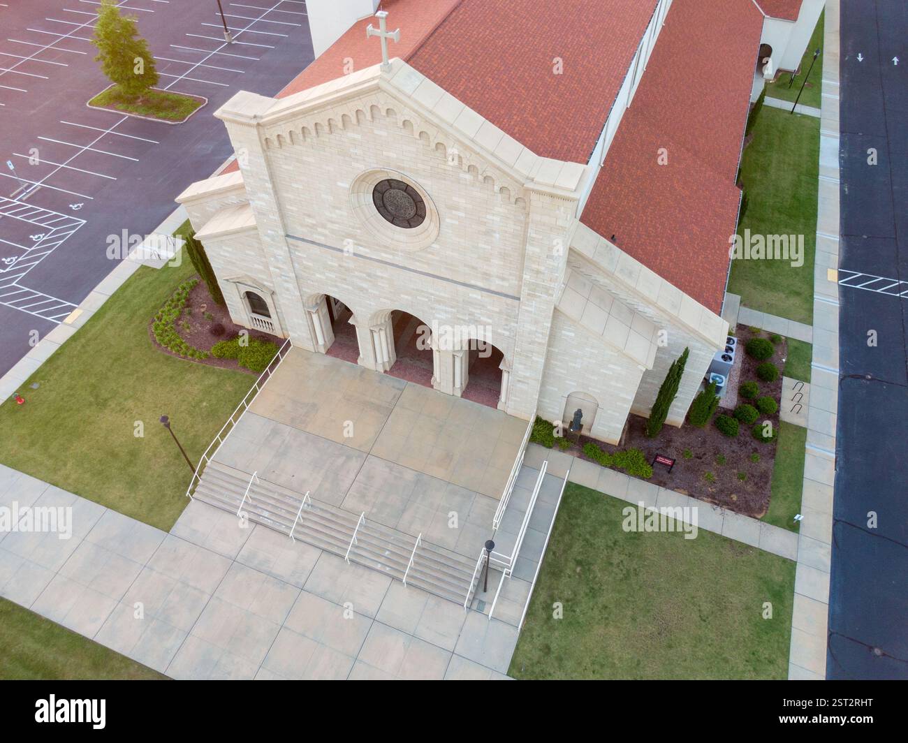 Afternoon Drone Images of a Cross Shaped Church With Red Asphalt ...