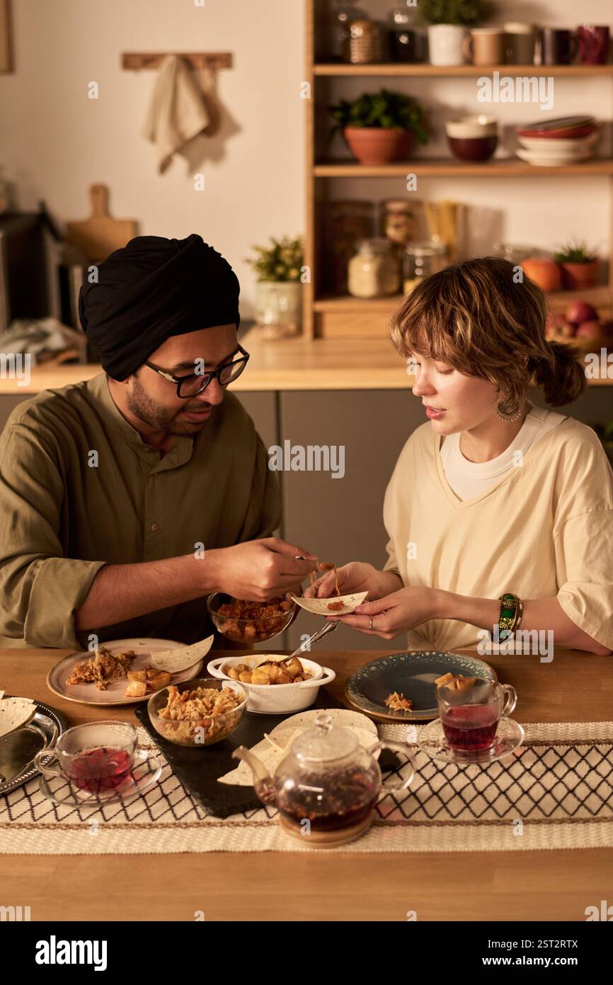 Man and woman sharing a meal in contemporary kitchen setting. Table ...