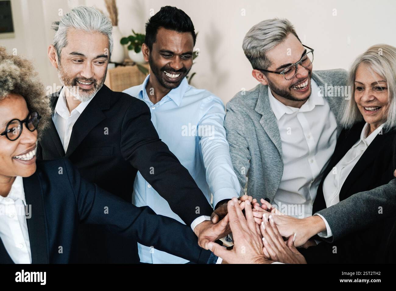 Business people join hands together celebrating as team building. Trust ...