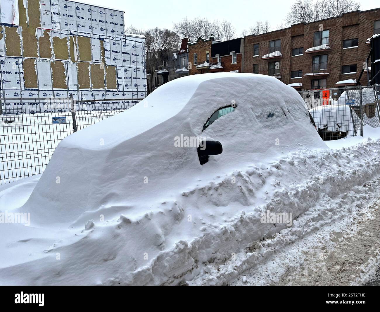 Montreal, Canada. 16th Feb, 2025. A car is seen under the snow during ...