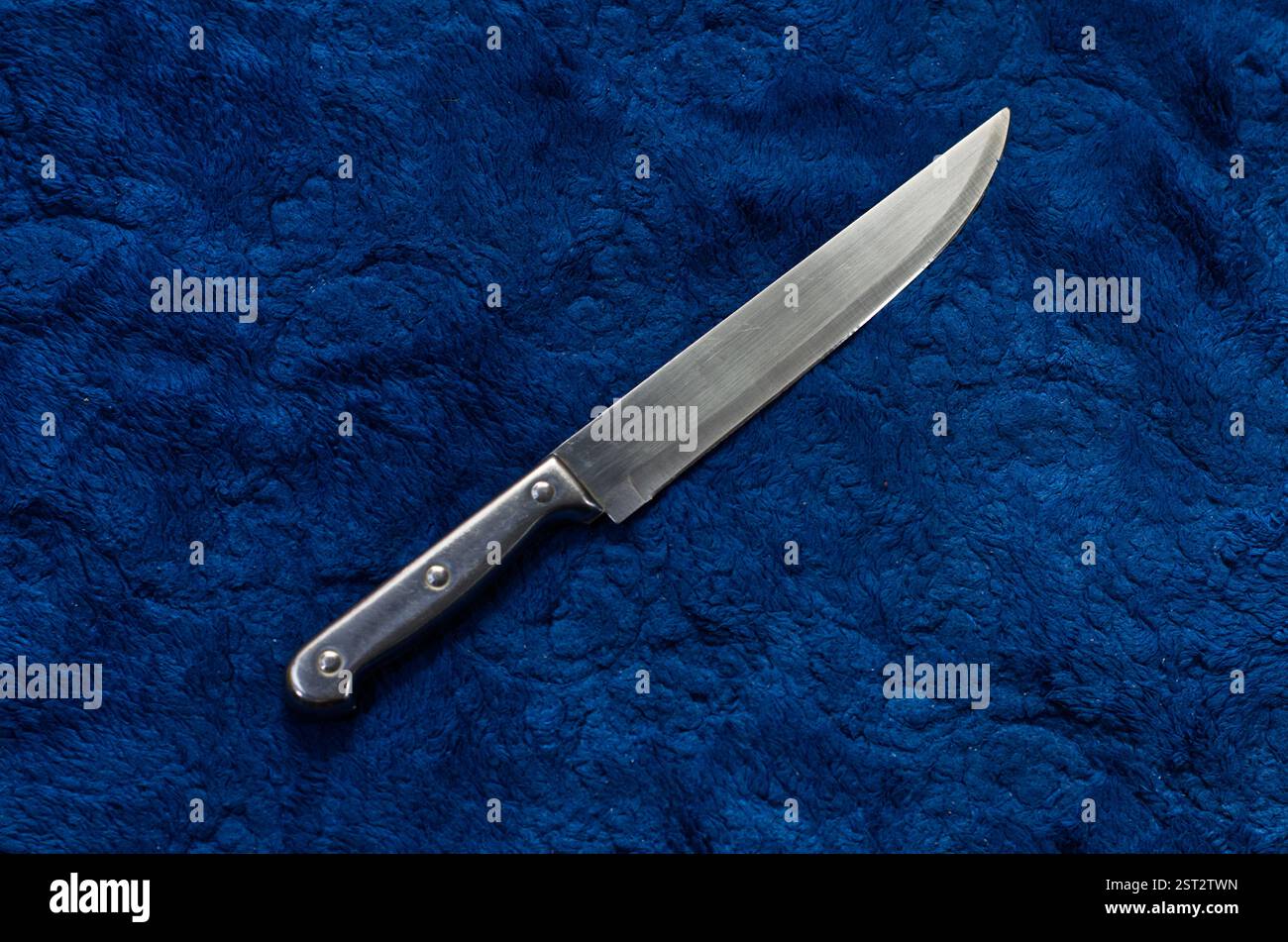 Steel Knife Placed on Deep Blue Textured Fabric Background Stock Photo ...