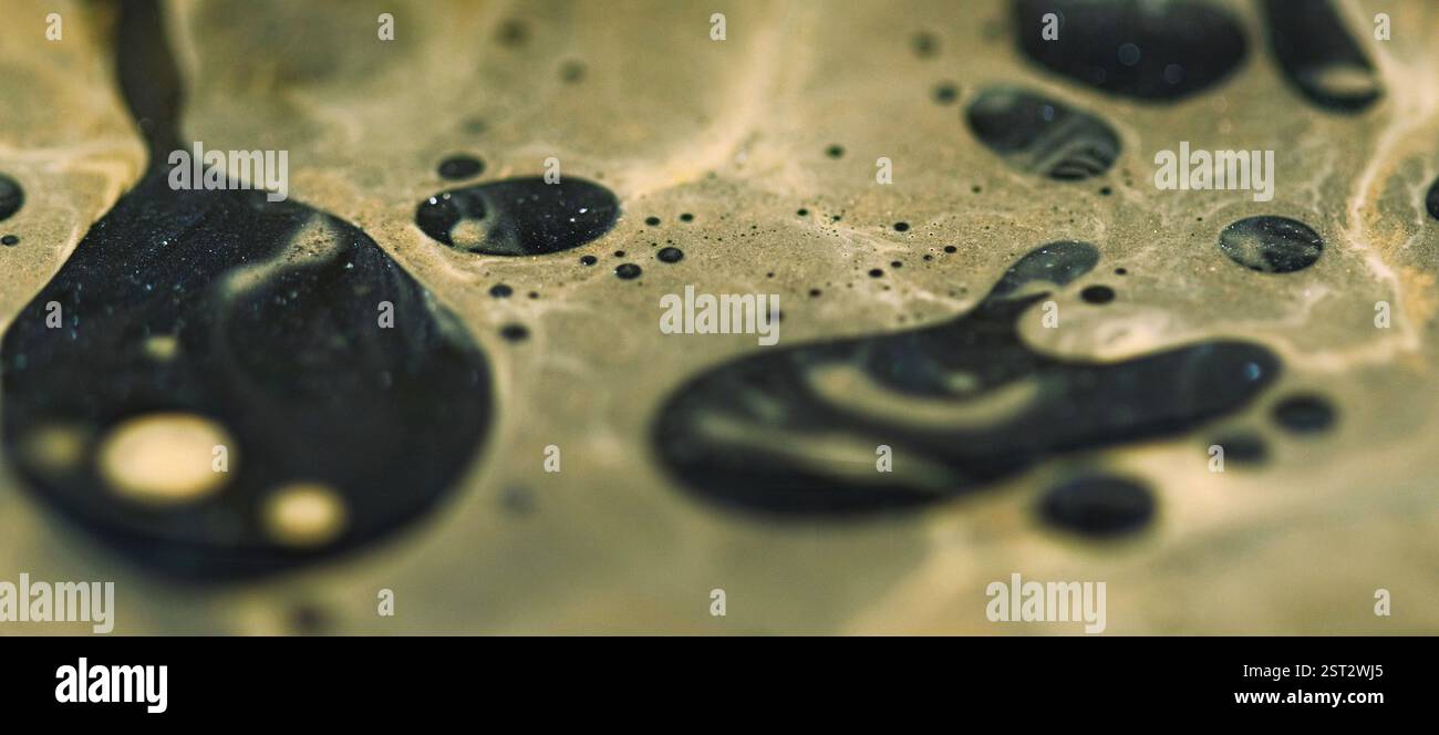 Serum blob. Blur fizzy liquid. Defocused yellow black color round oil ...