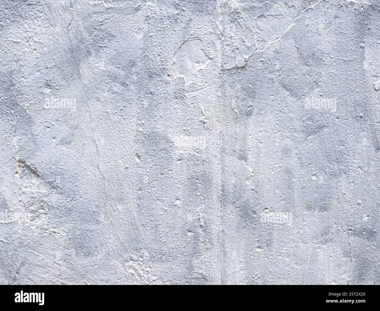 old rough plaster wall painted white. aged surface with brush strokes ...