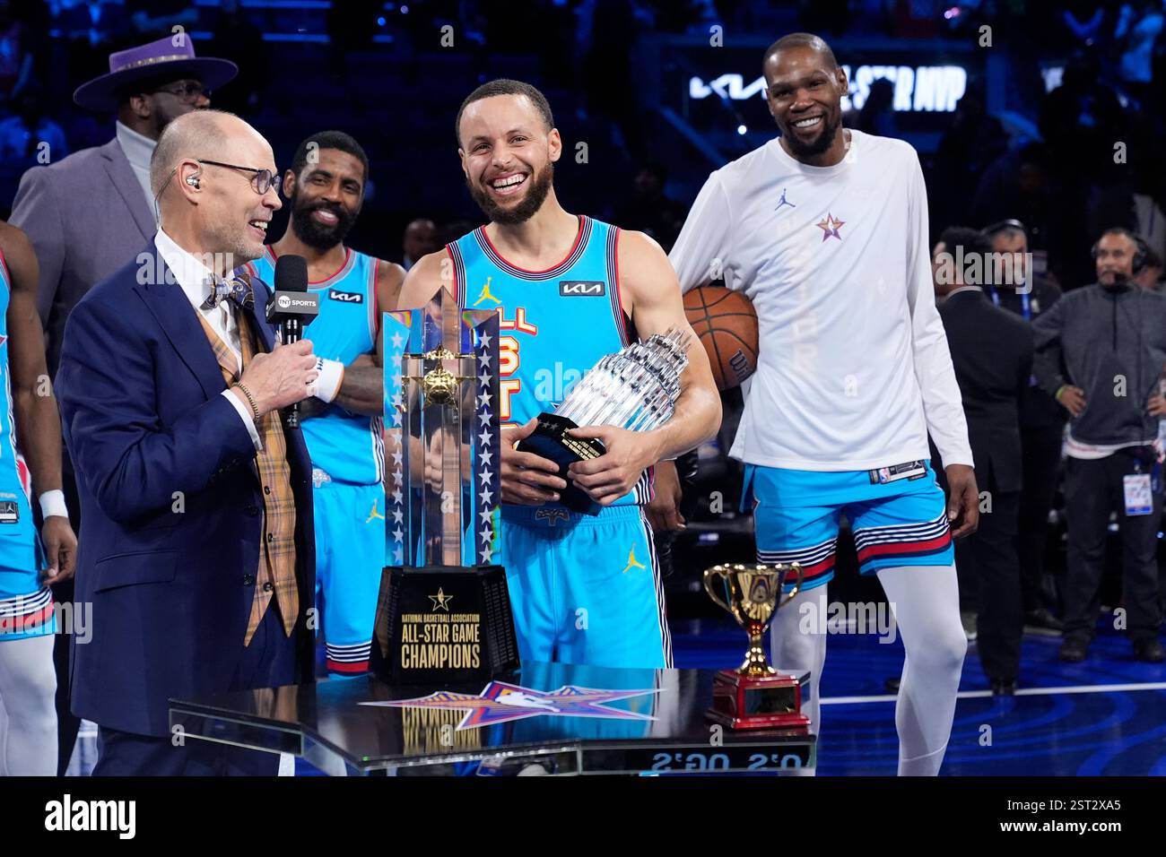 Golden State Warriors guard Stephen Curry holds the Most Valuable Player trophy next to Ernie ...