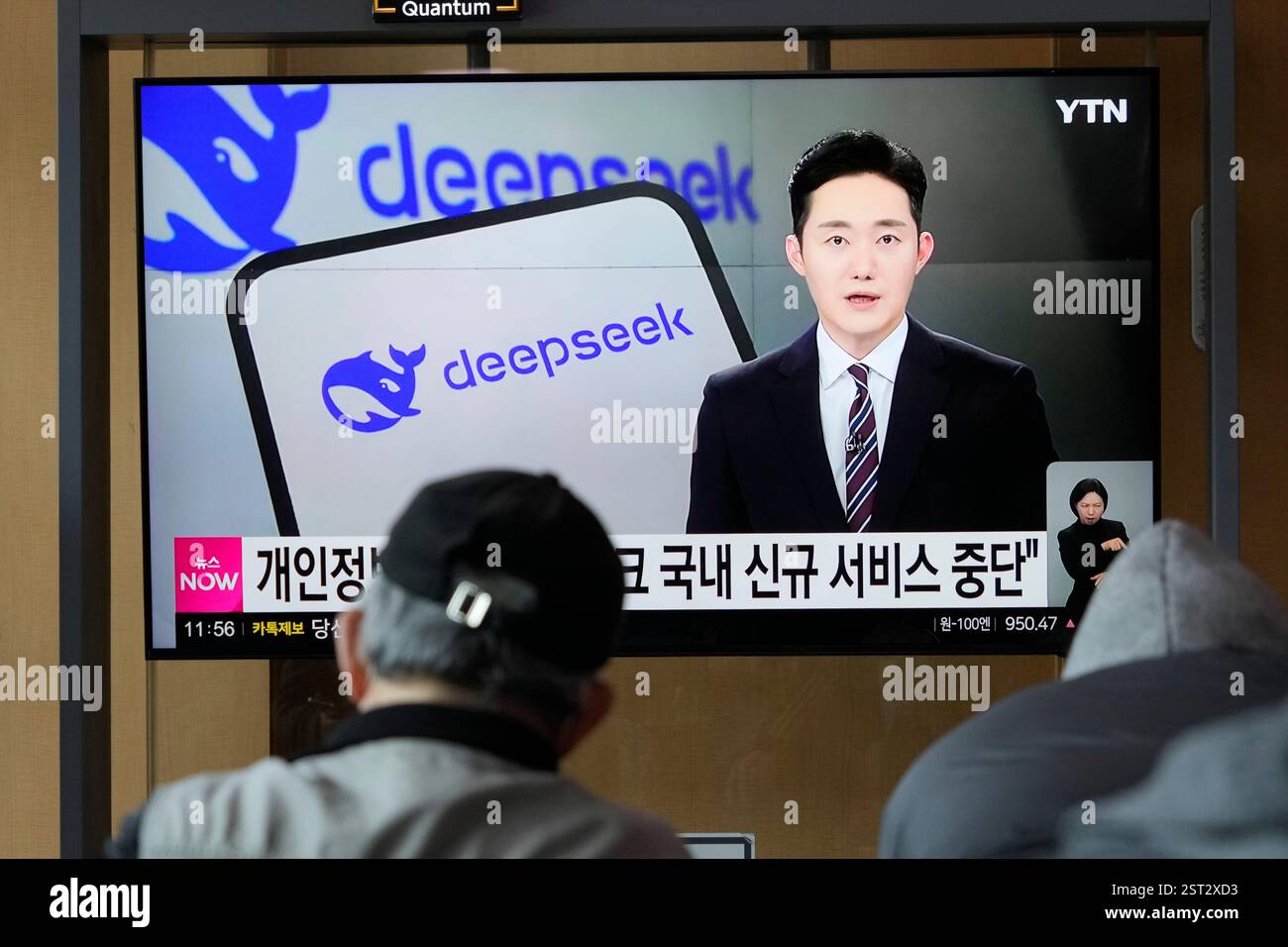 People watch a TV reporting DeepSeek, a Chinese artificial intelligence ...