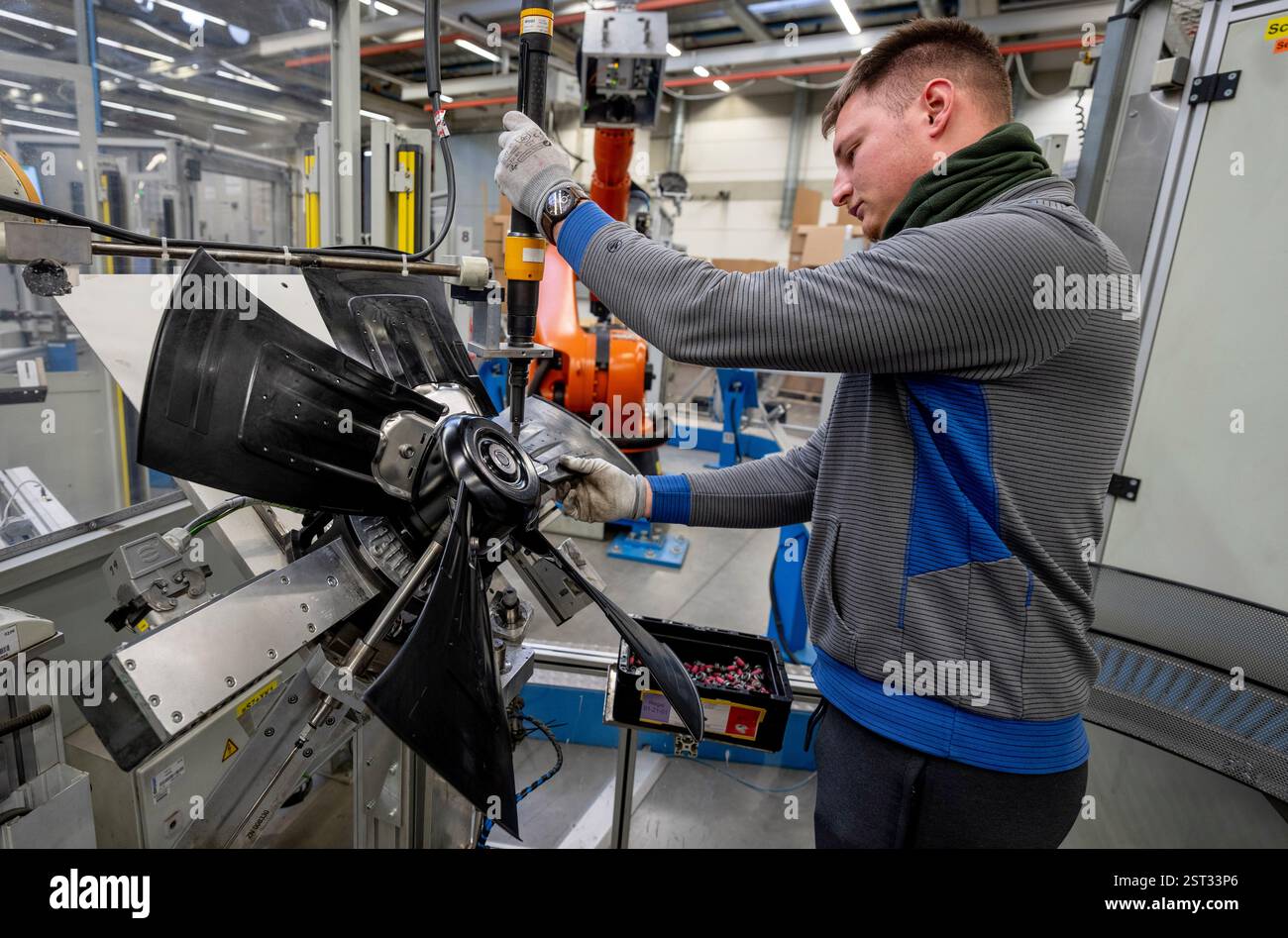 A man works on fans at an EBM-Papst plant in Hollenbach, Germany ...