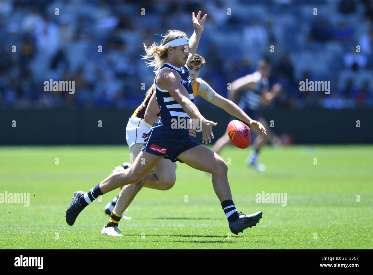 Geelong, Australia. 17th Feb, 2025. Cats player Bailey Smith (front) is ...