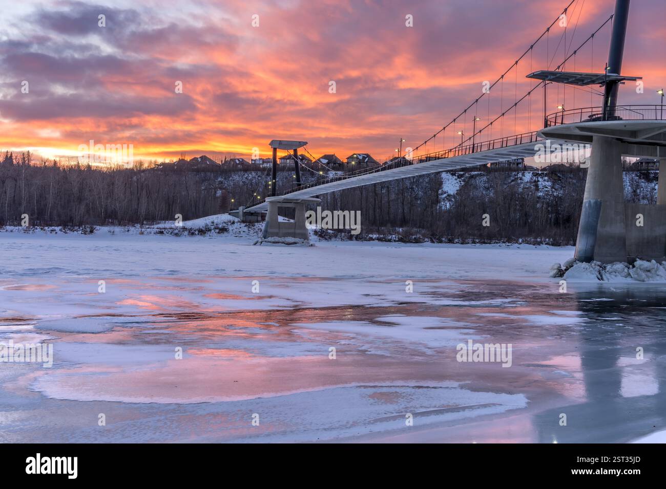 Fort Edmonton Footbridge at sunset in winter season with red color in ...
