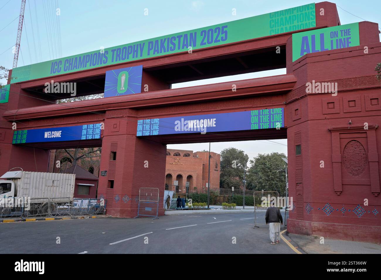 Workers install billboards on a structure of an entry point to Gaddafi ...