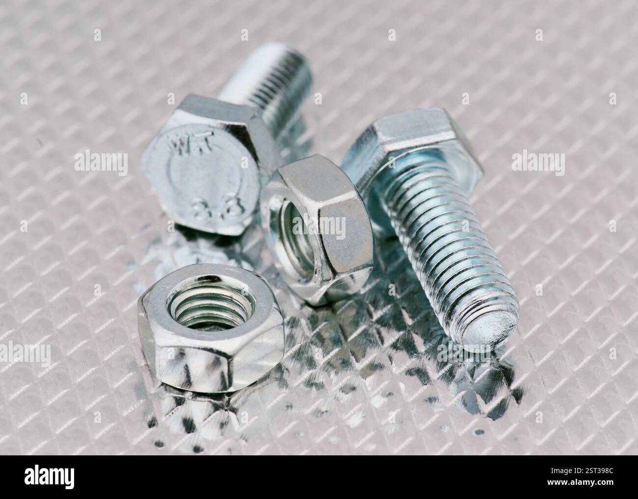 A collection of metal fasteners featuring bolts and nuts displayed on a ...