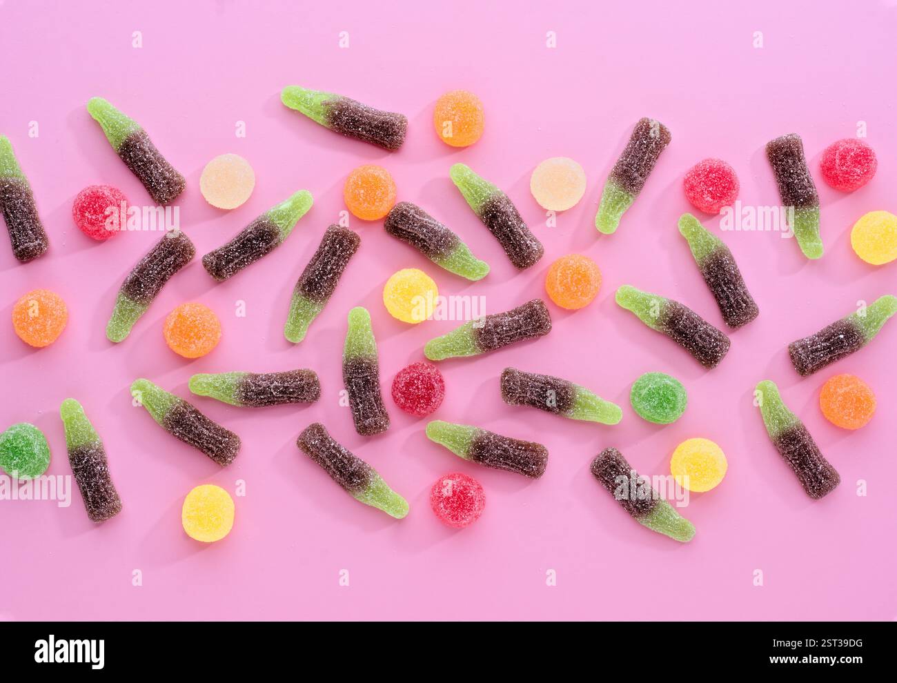 A vibrant collection of assorted candies, including gummy bottles and ...
