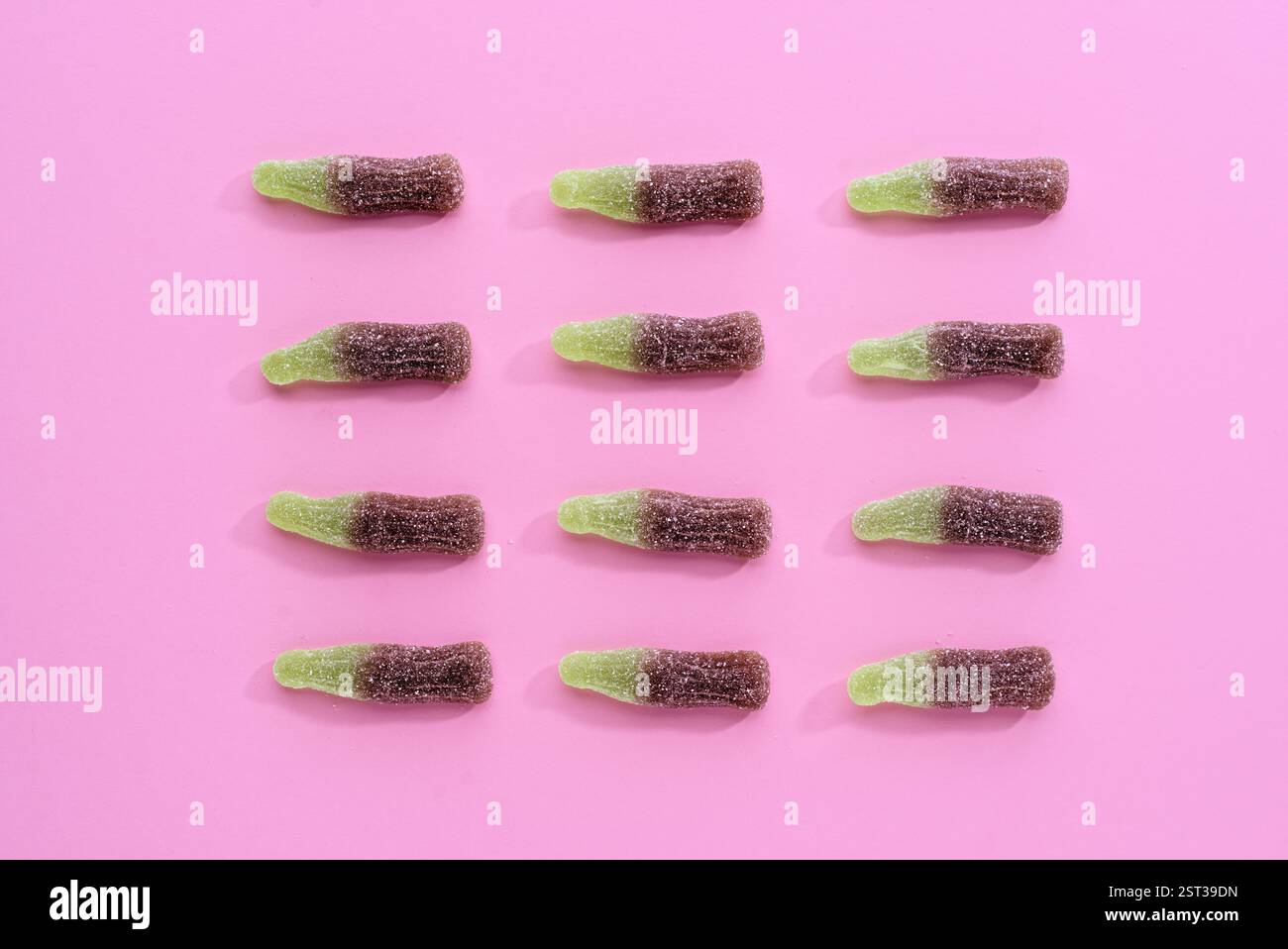 A group of twelve gummy candies is displayed in a neat grid. Each candy ...