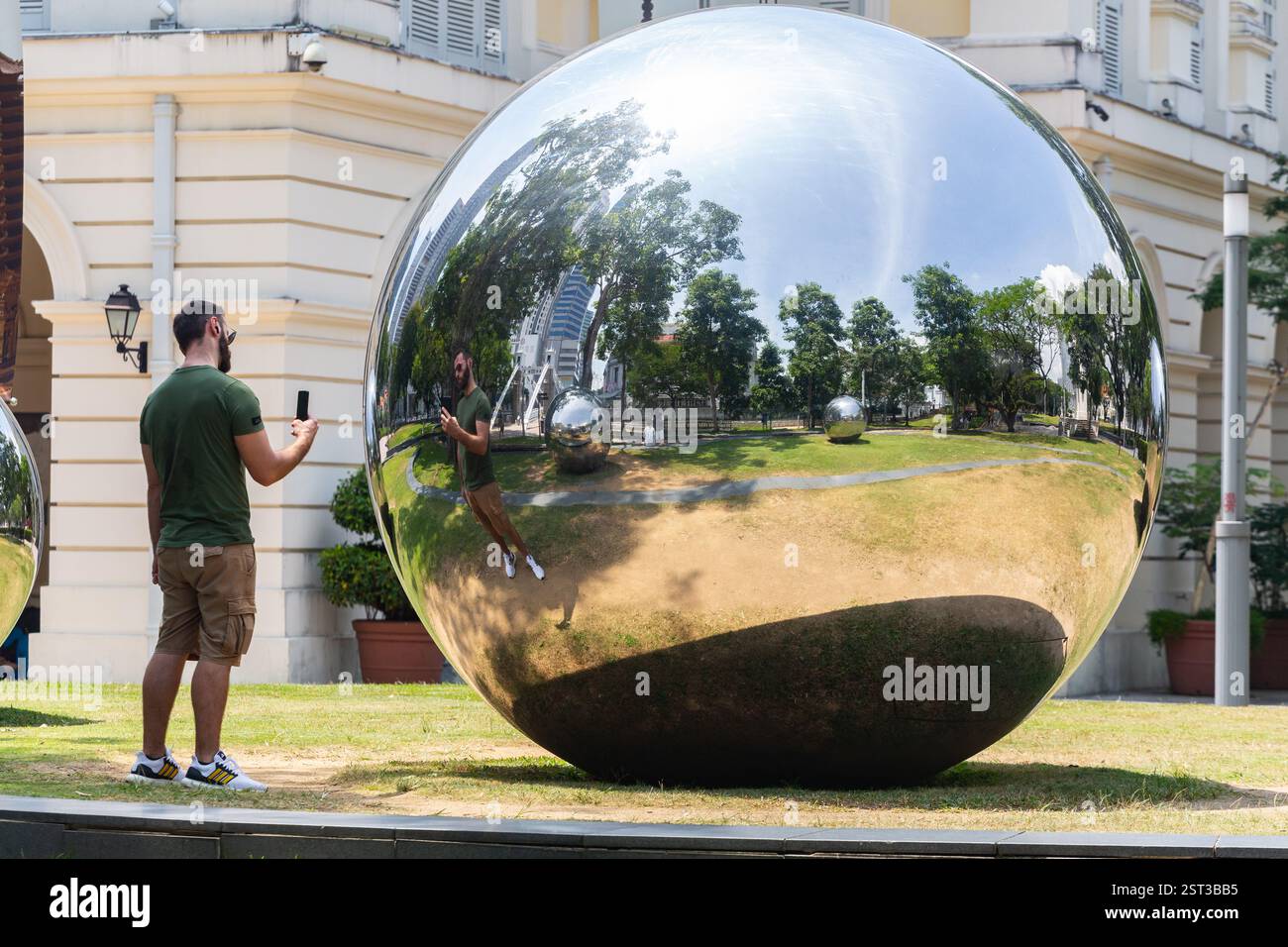 24 Hours in Singapore by artist Baet Yeok Kuan. A visitor taking a shot ...