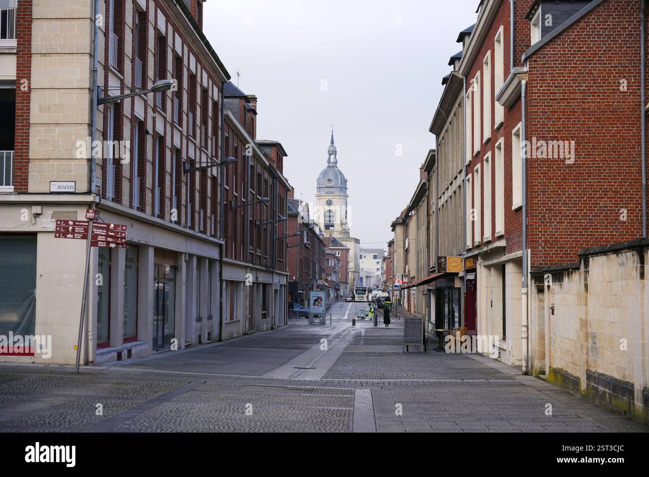 Urban street scene featuring red-brick buildings and a church tower in ...
