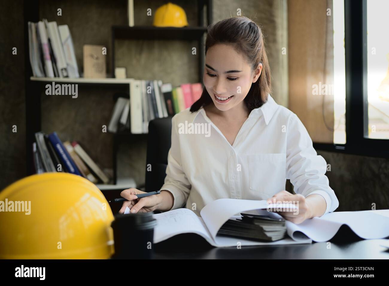 A professional, successful Asian female architect boss is working on a ...