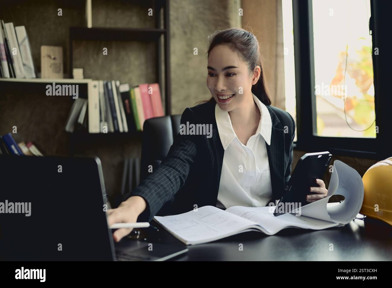 A confident, attractive Asian female engineer boss in a formal business ...