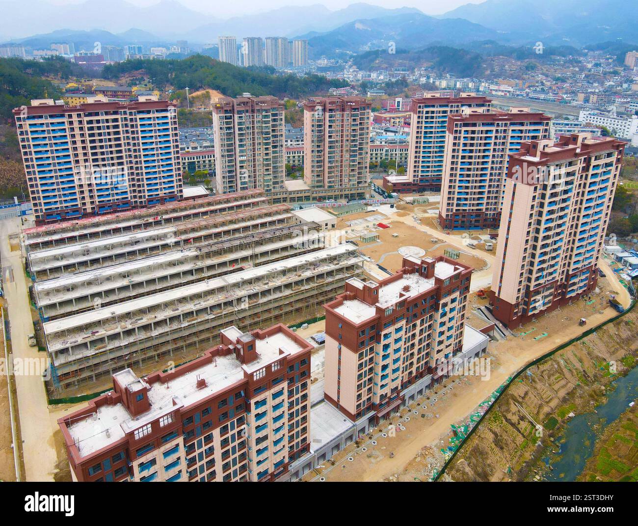 Builders are working at the construction site of a resettlement area ...