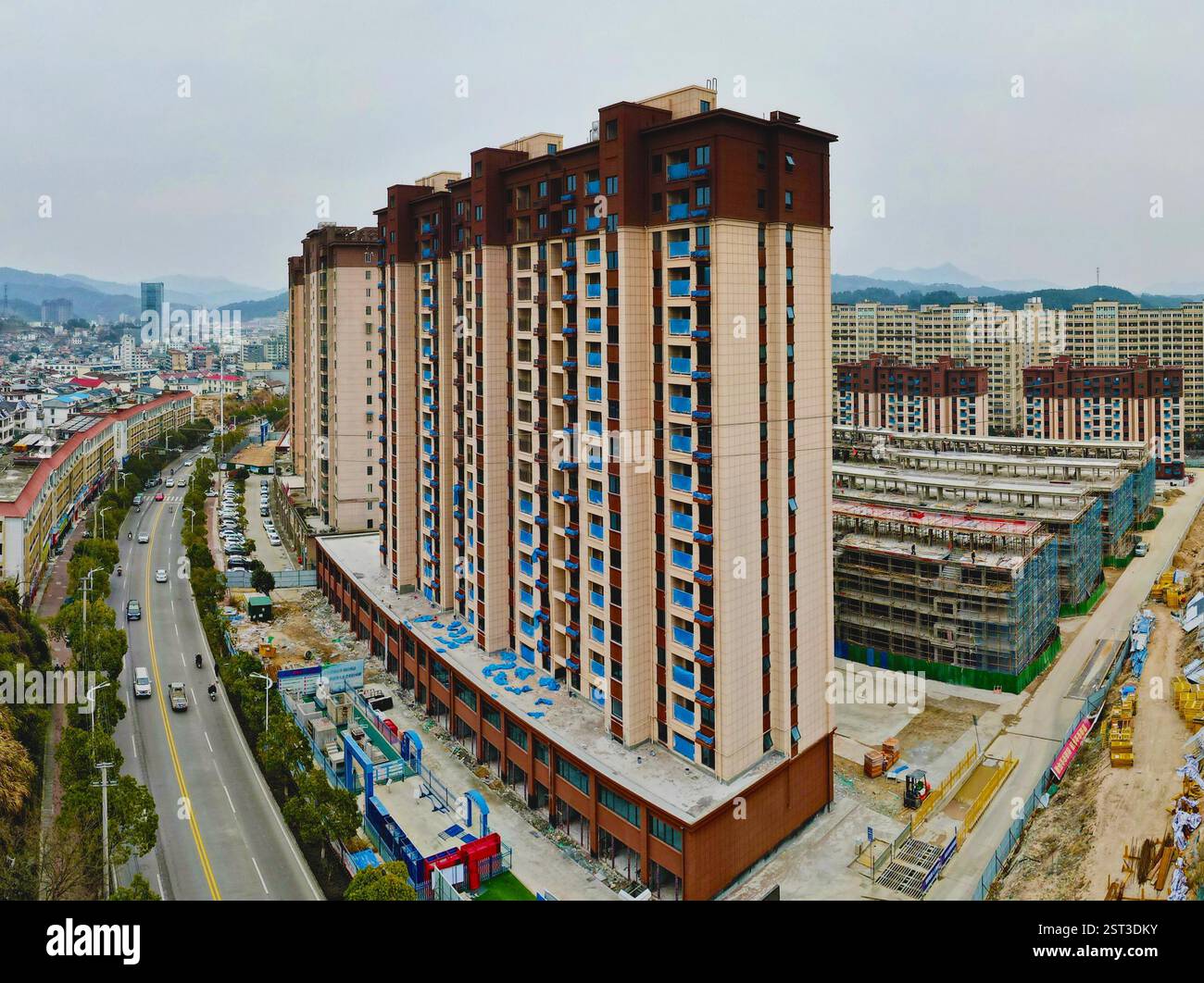 Builders are working at the construction site of a resettlement area ...
