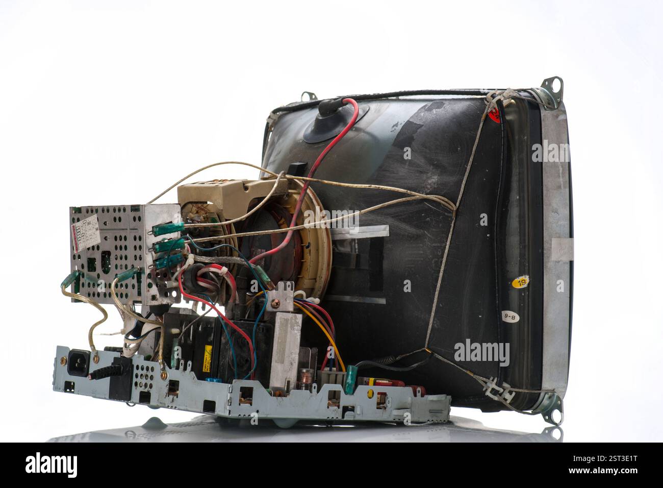 An old television set is disassembled, revealing its internal ...