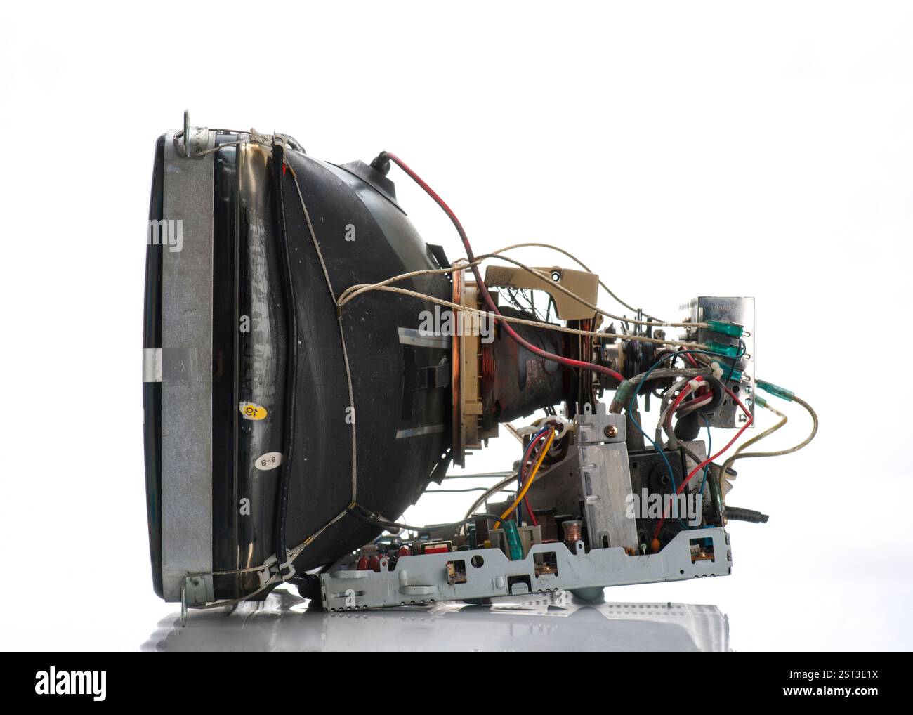 An old television set is disassembled to reveal its internal components ...