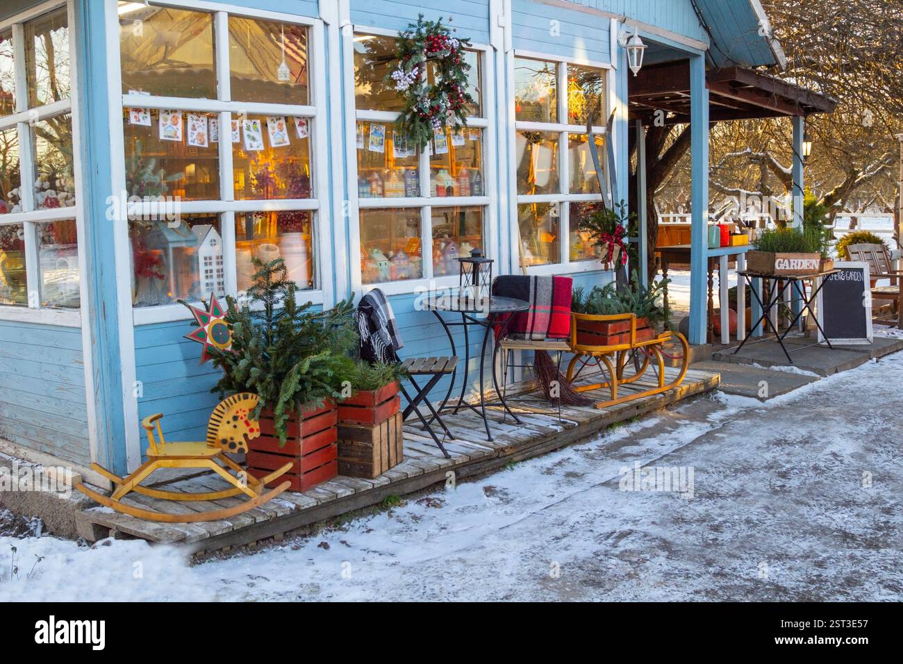 The facade of a wooden cafe building. Under the cafe windows there is a ...