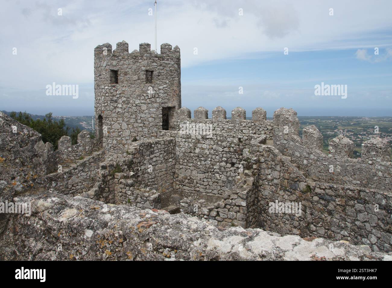 Sintra, Portugal. Ancient ruins crown a hill, overlooking vibrant green ...