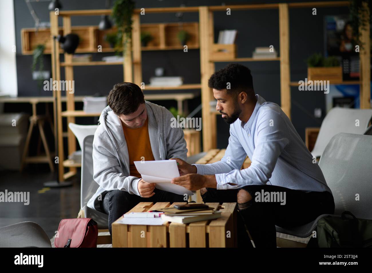 Young man with Down syndrome studyng with special educator teacher in ...