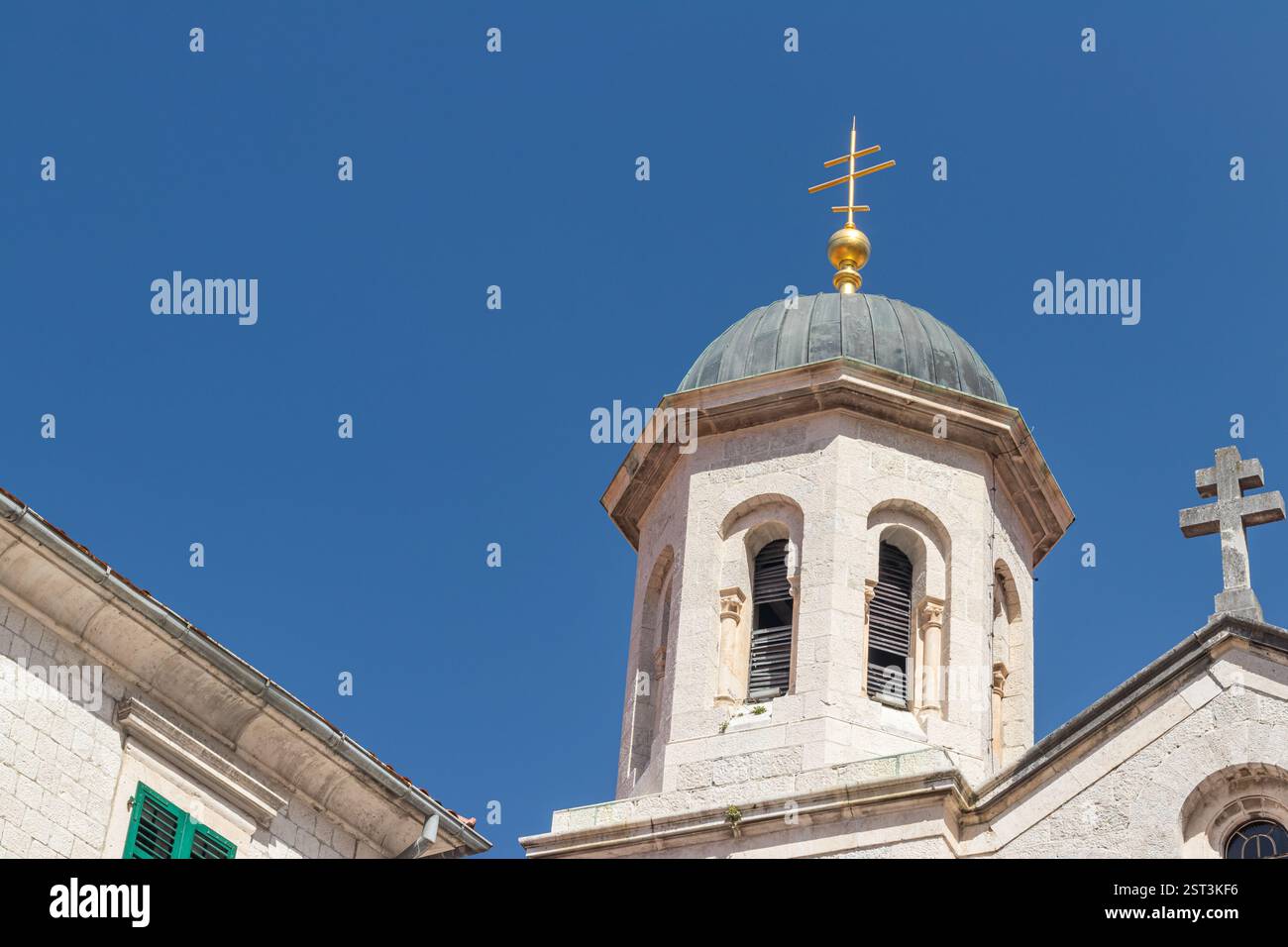 A traditional church with stonework and bell towers seen against a ...
