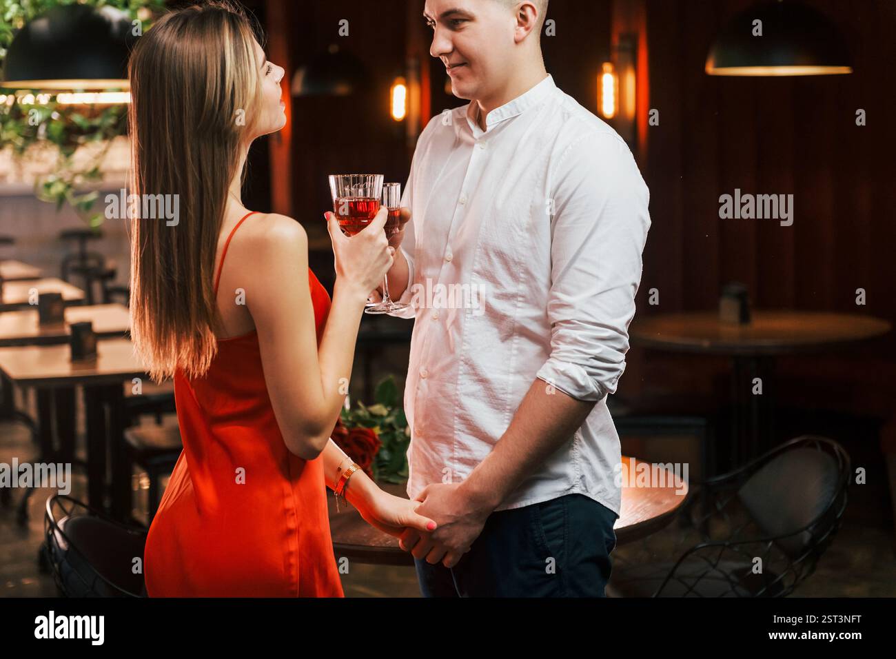 Two people standing together. Romantic couple have dinner in the ...